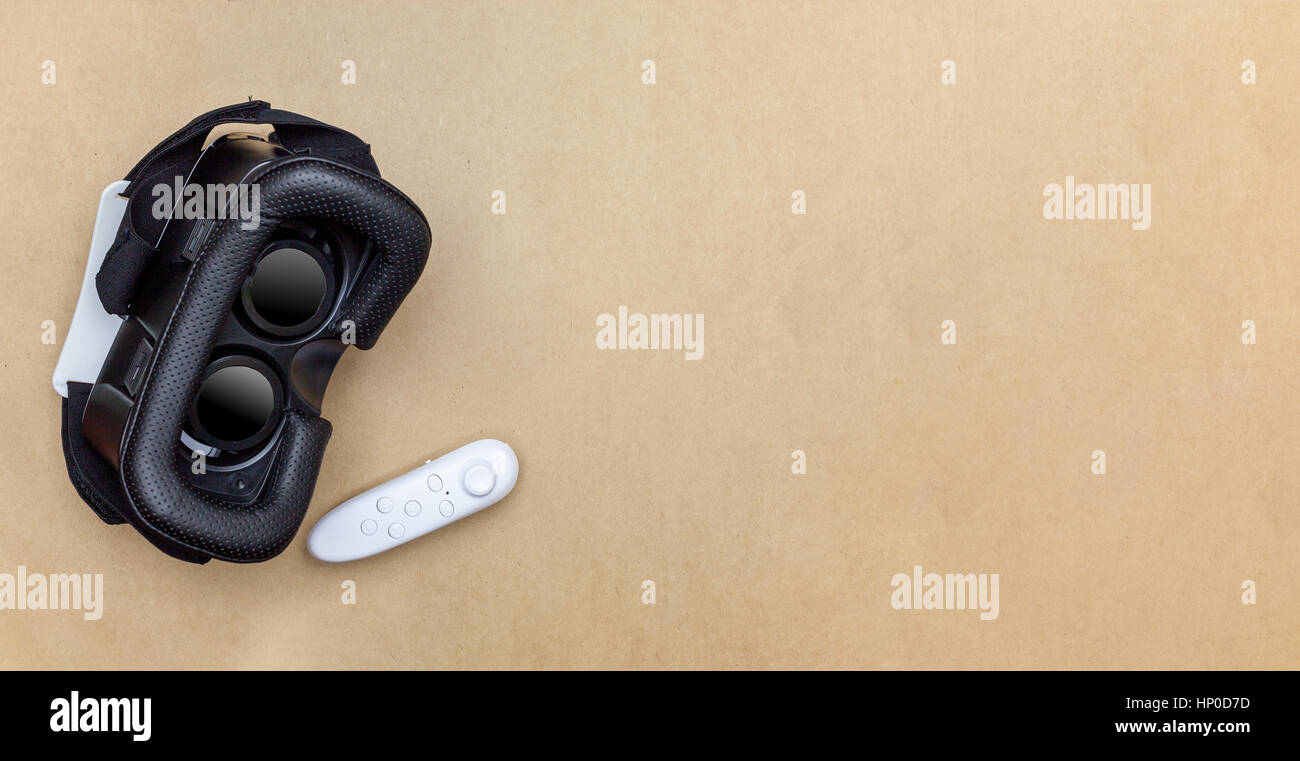 3d virtual glasses and bluetooth joy stick on brown paper background ...