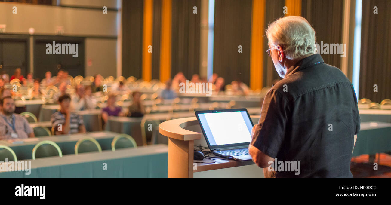 Senior public speaker giving talk at scientific conference Stock Photo ...