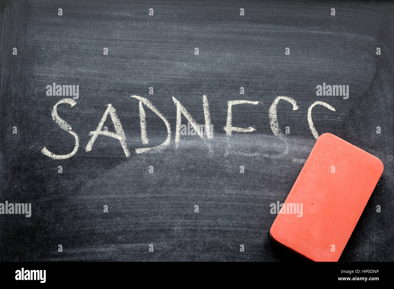 erasing sadness, hand written word on blackboard being erased concept ...
