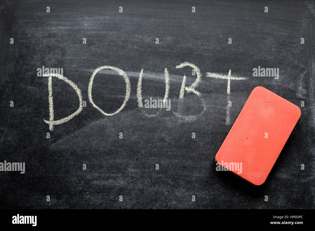 erasing doubt, hand written word on blackboard being erased concept ...