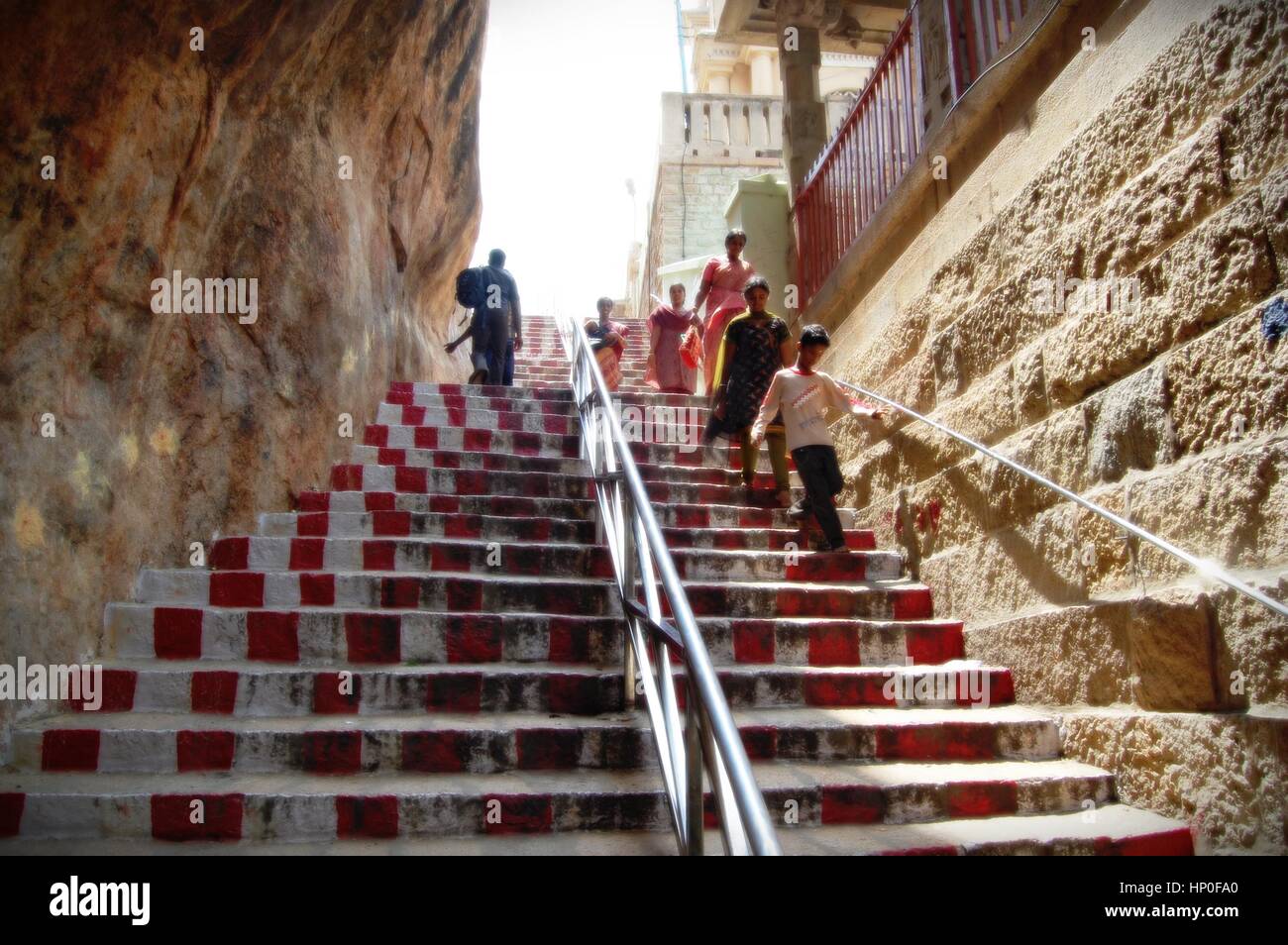 Hindu pilgrims climbing the steps up to the Rock Temple in Thanjavur ...