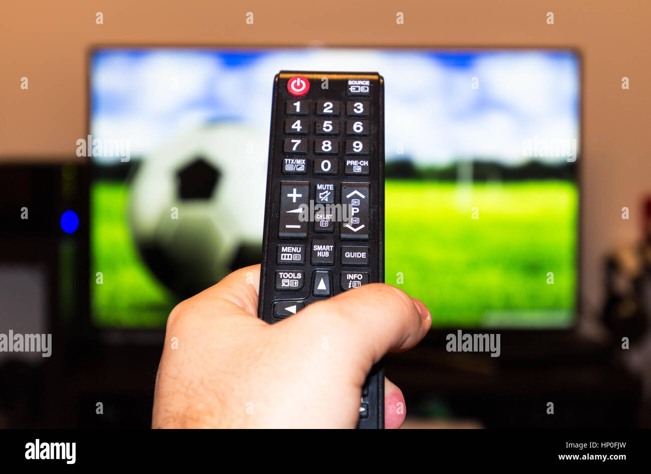 Watching soccer / football game on modern tv, with a close-up of the ...