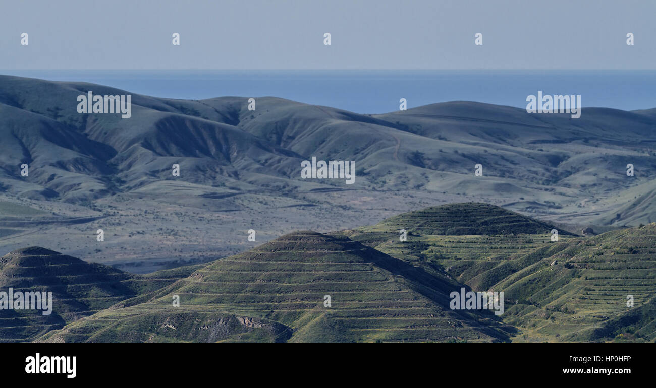 Mounds in the form of pyramids on the background of mountain scenery ...