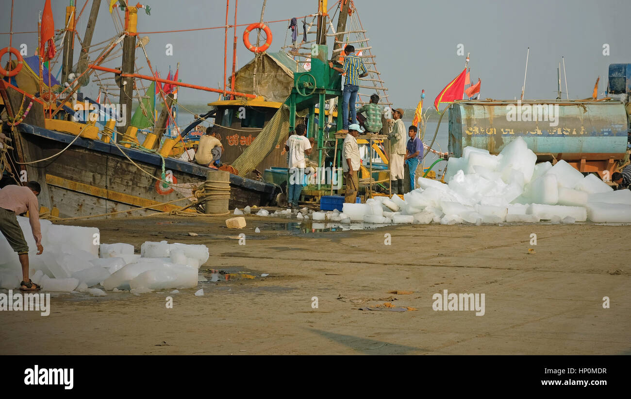 Fishing crews loading ice on board their boats to preserve their ...