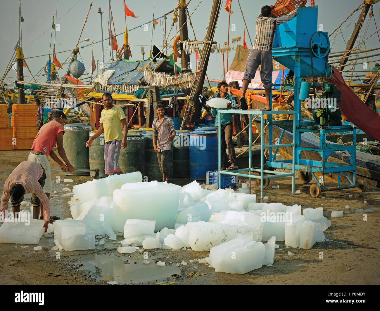 Fishing crews loading ice on board their boats to preserve their ...