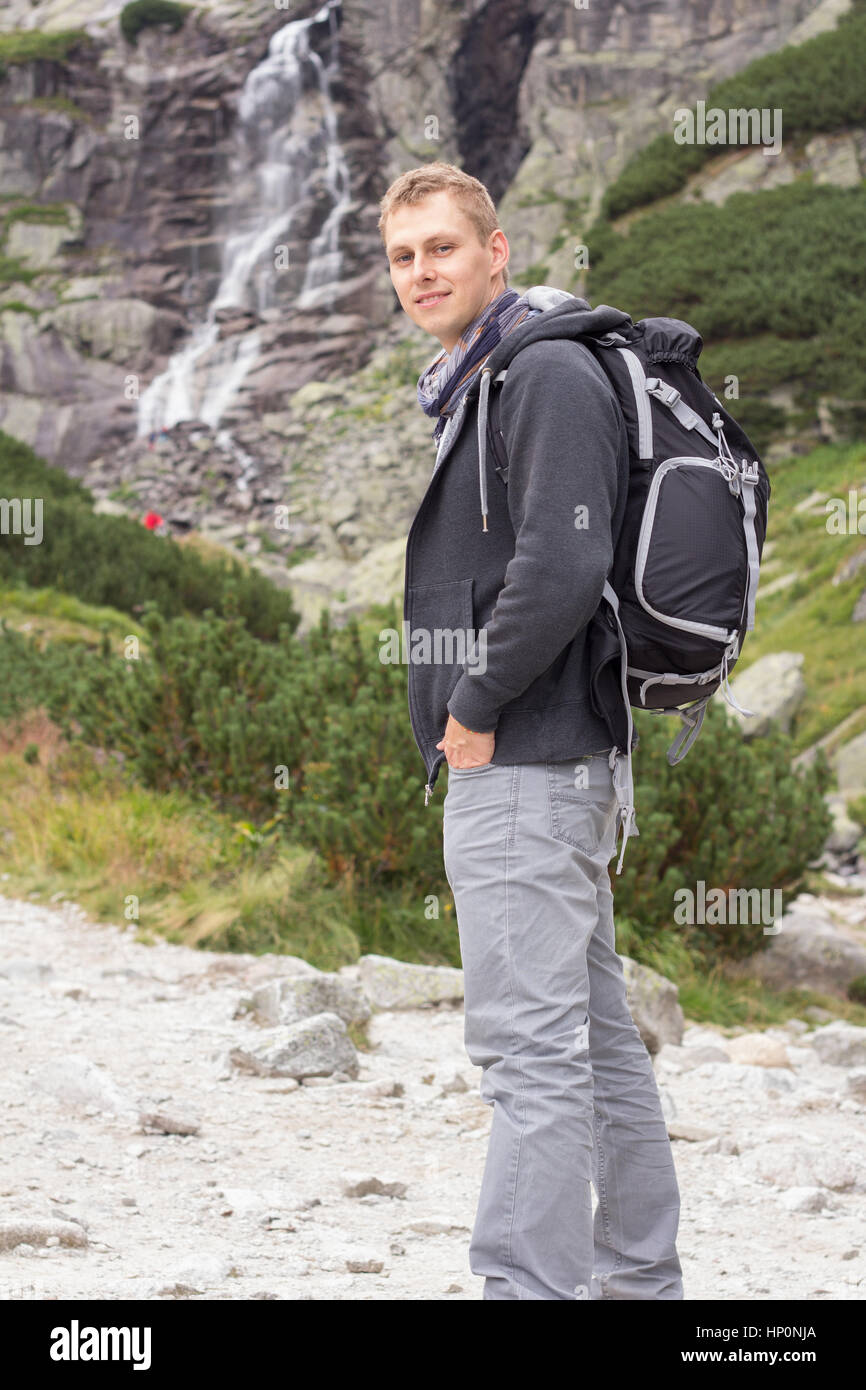 tourist man in nature with waterfall Stock Photo - Alamy