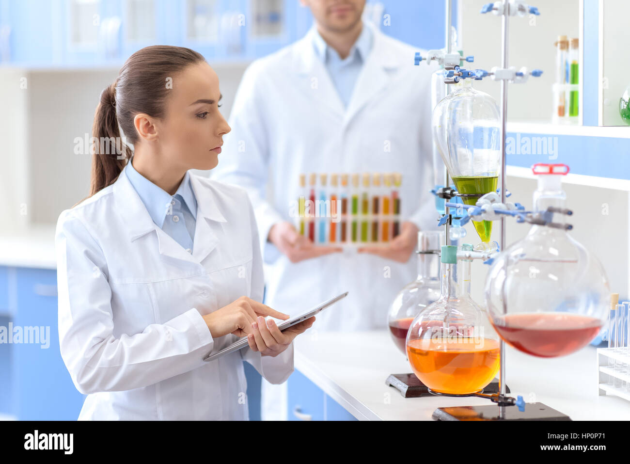 scientist holding digital tablet and inspecting reagents in lab Stock ...