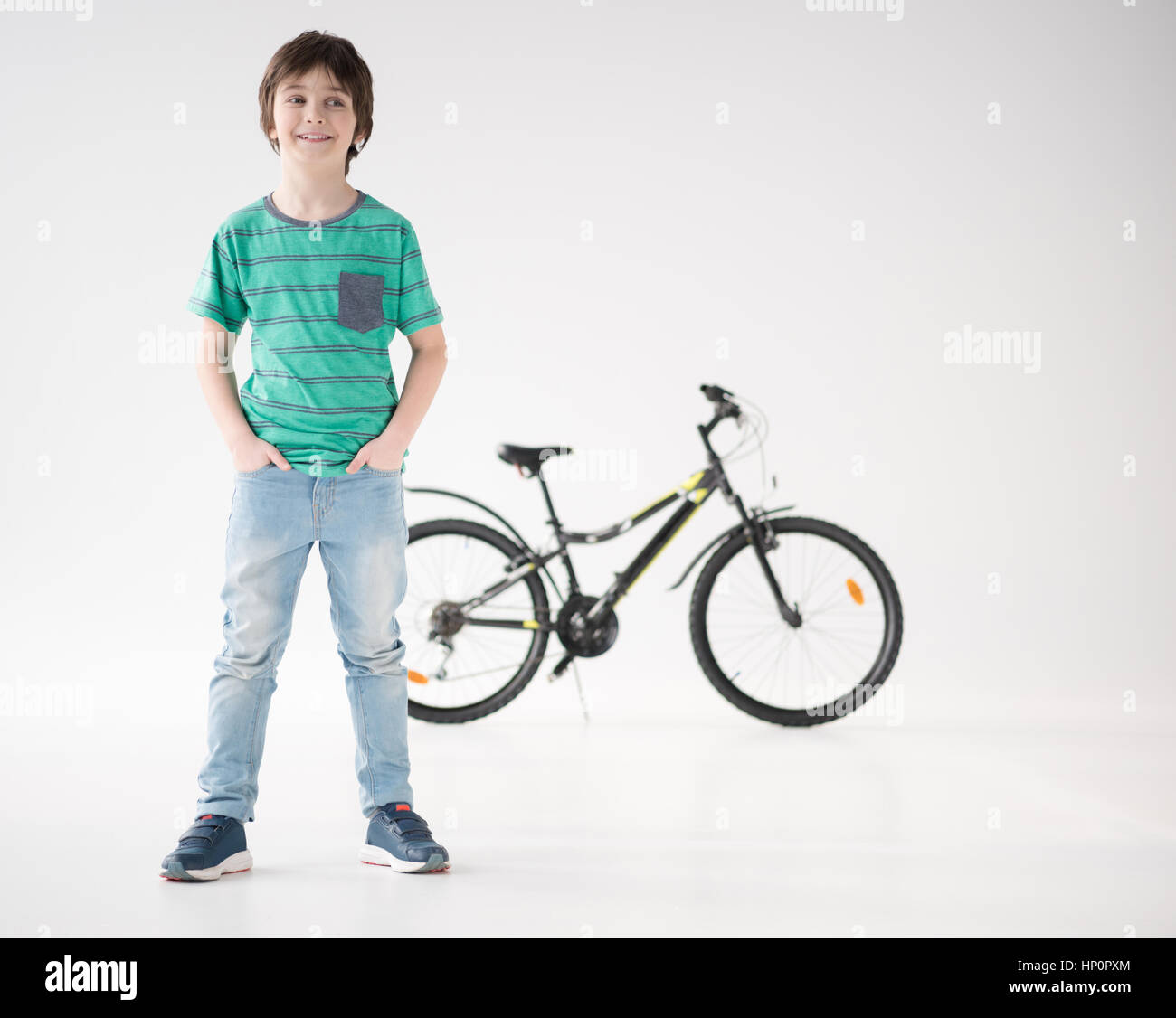 Boy standing with bicycle hi-res stock photography and images - Alamy