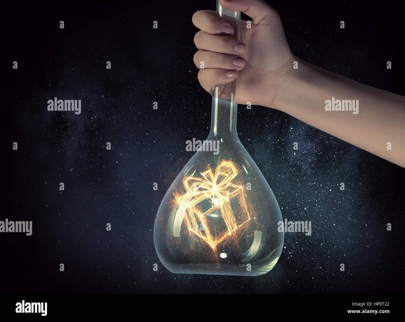 Close up of human hand holding test tube with gift concept Stock Photo ...