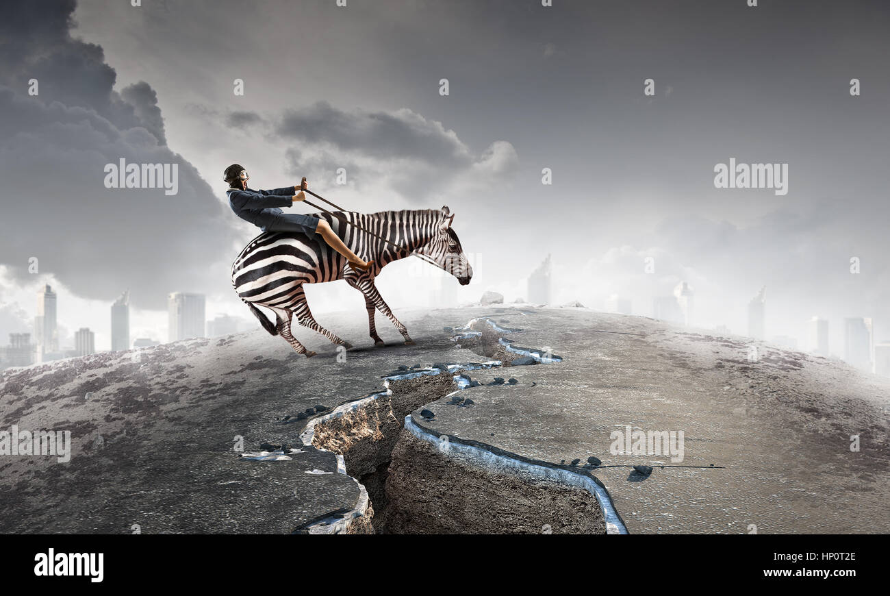 Young pretty fearless woman riding zebra animal Stock Photo - Alamy