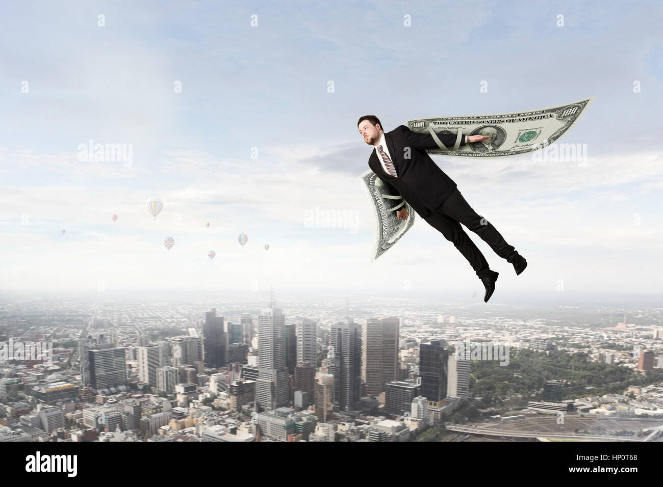 Businessman flying in sky with dollar bills wings Stock Photo - Alamy