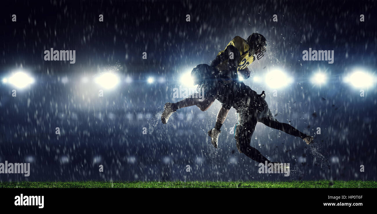 Two american football players fighting for ball. Mixed media Stock ...