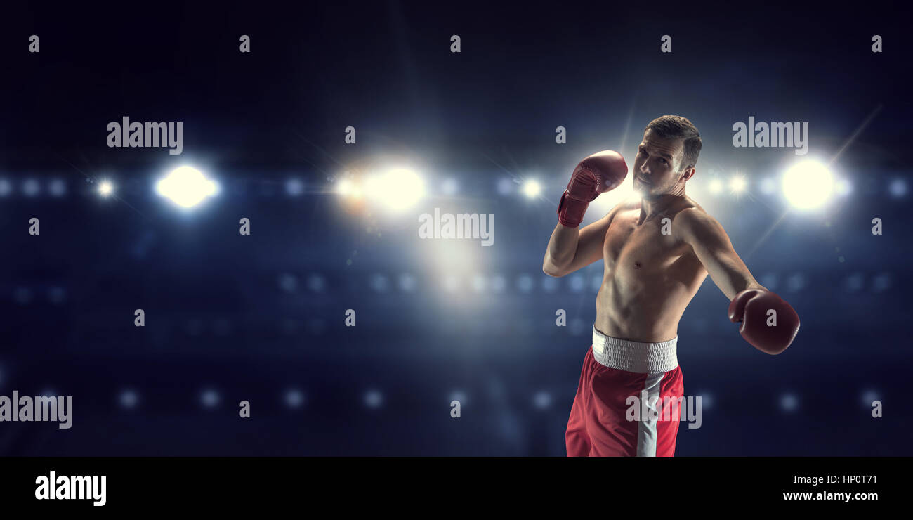 Determined man in box gloves ready to fight. Mixed media Stock Photo ...