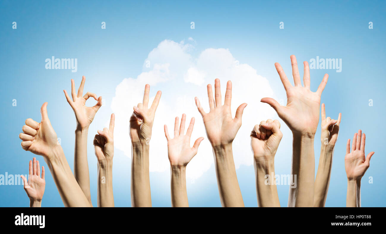 Row of raised hands showing different gestures Stock Photo - Alamy