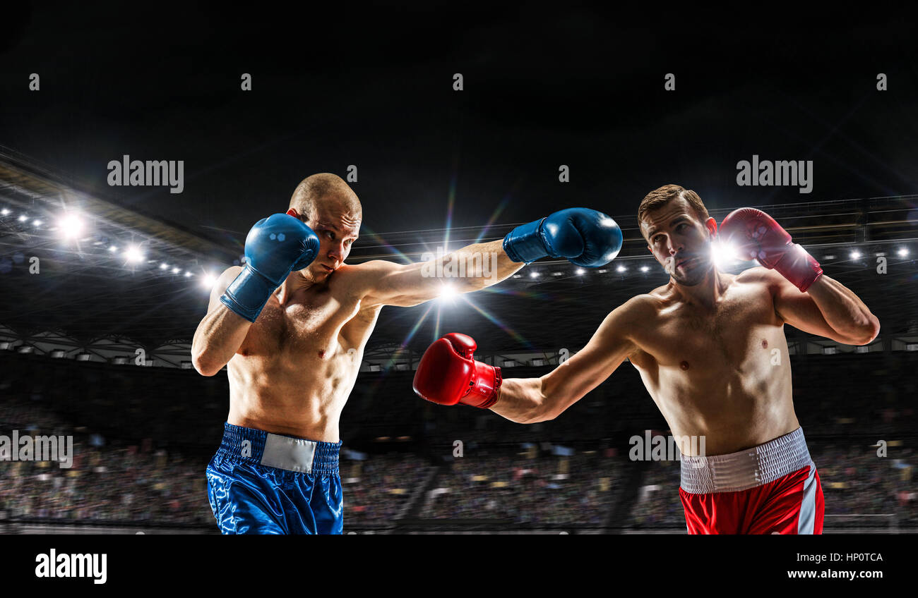 Two professional boxers fighting at sport arena. Mixed media Stock ...