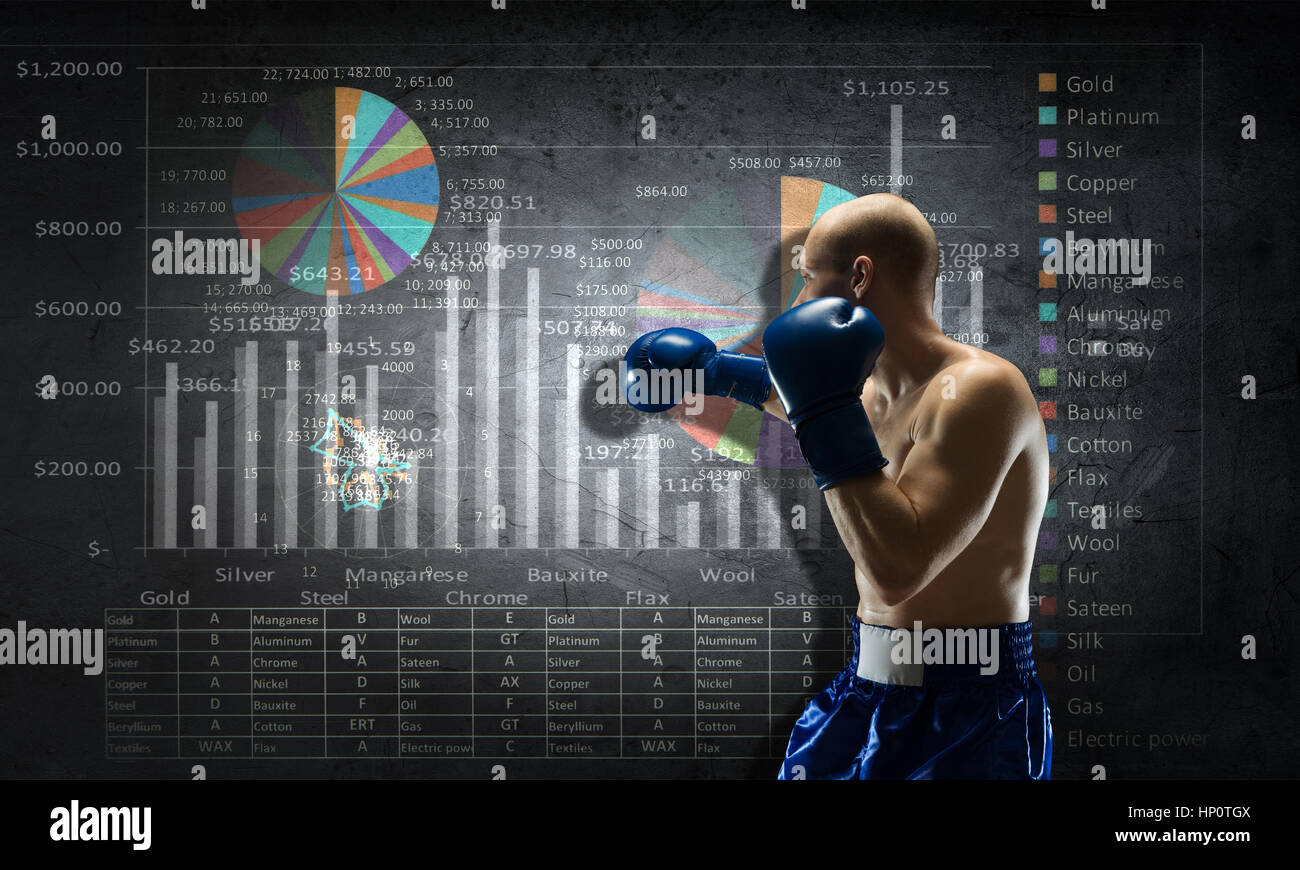 Young determined man boxing against graphs background. Mixed media ...