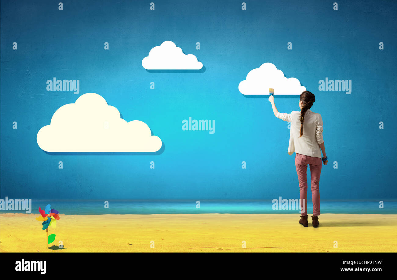 Young woman drawing happiness and positivity concept on wall Stock ...