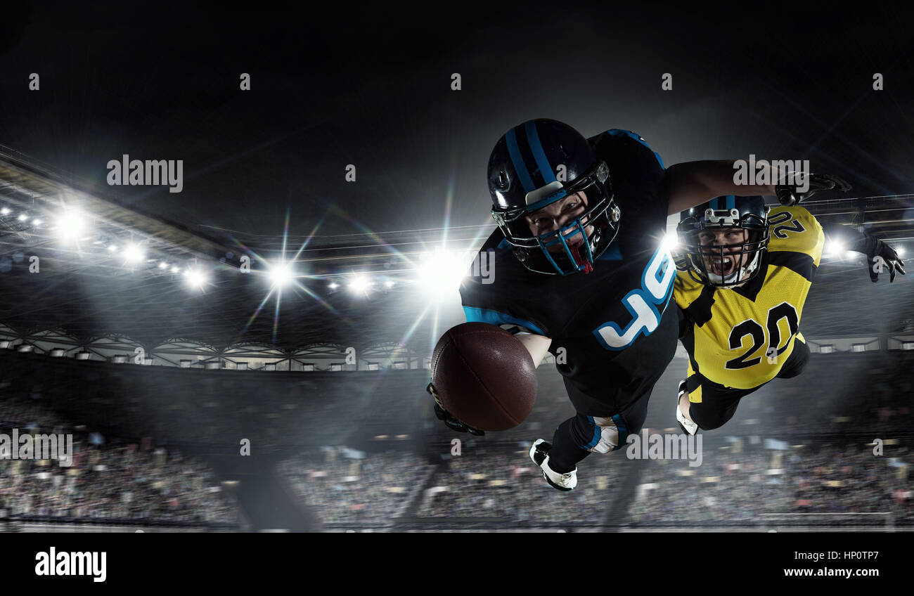 Two american football players fighting for ball. Mixed media Stock ...