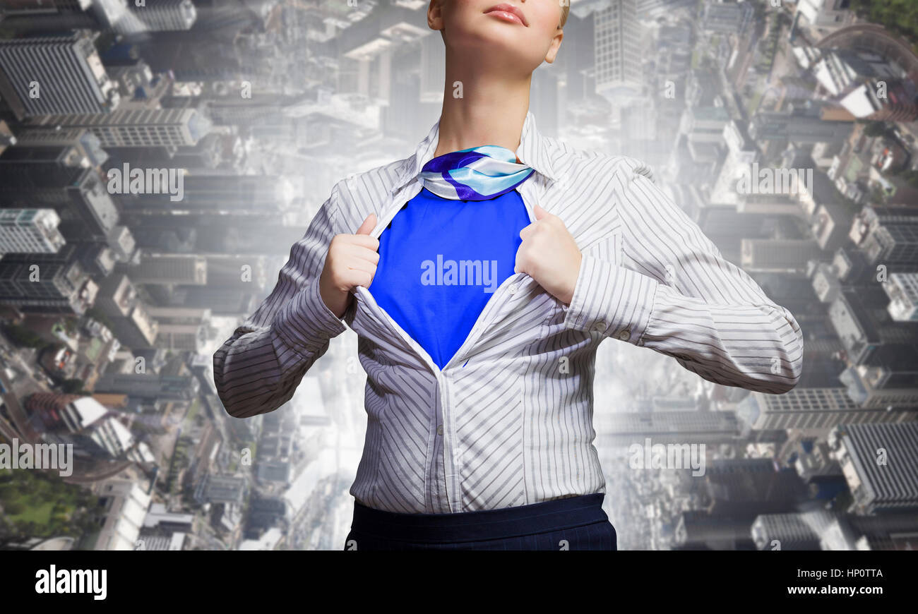 Young businesswoman tearing shirt on chest and acting like super hero ...