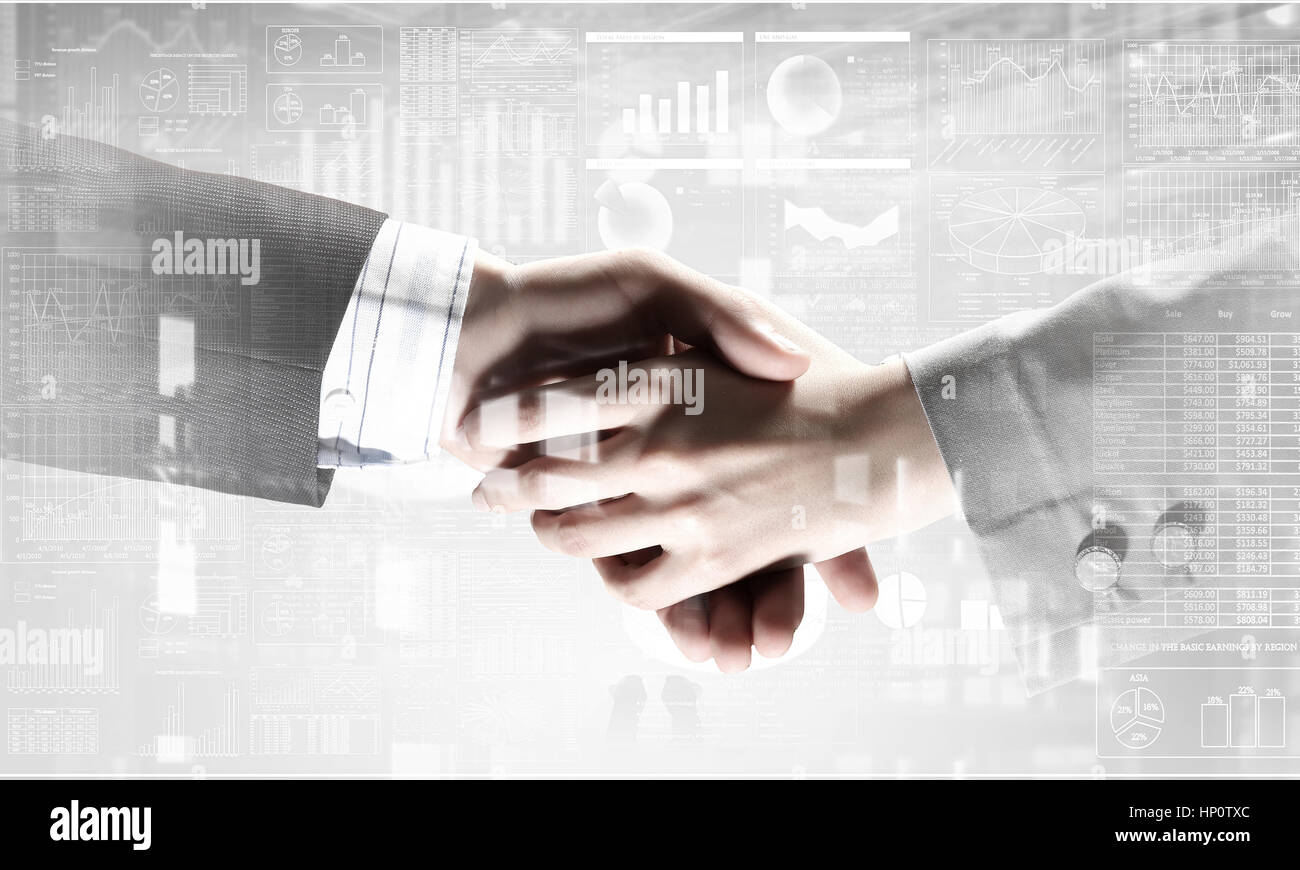 Business handshake or greeting against graphs and diagrams background ...