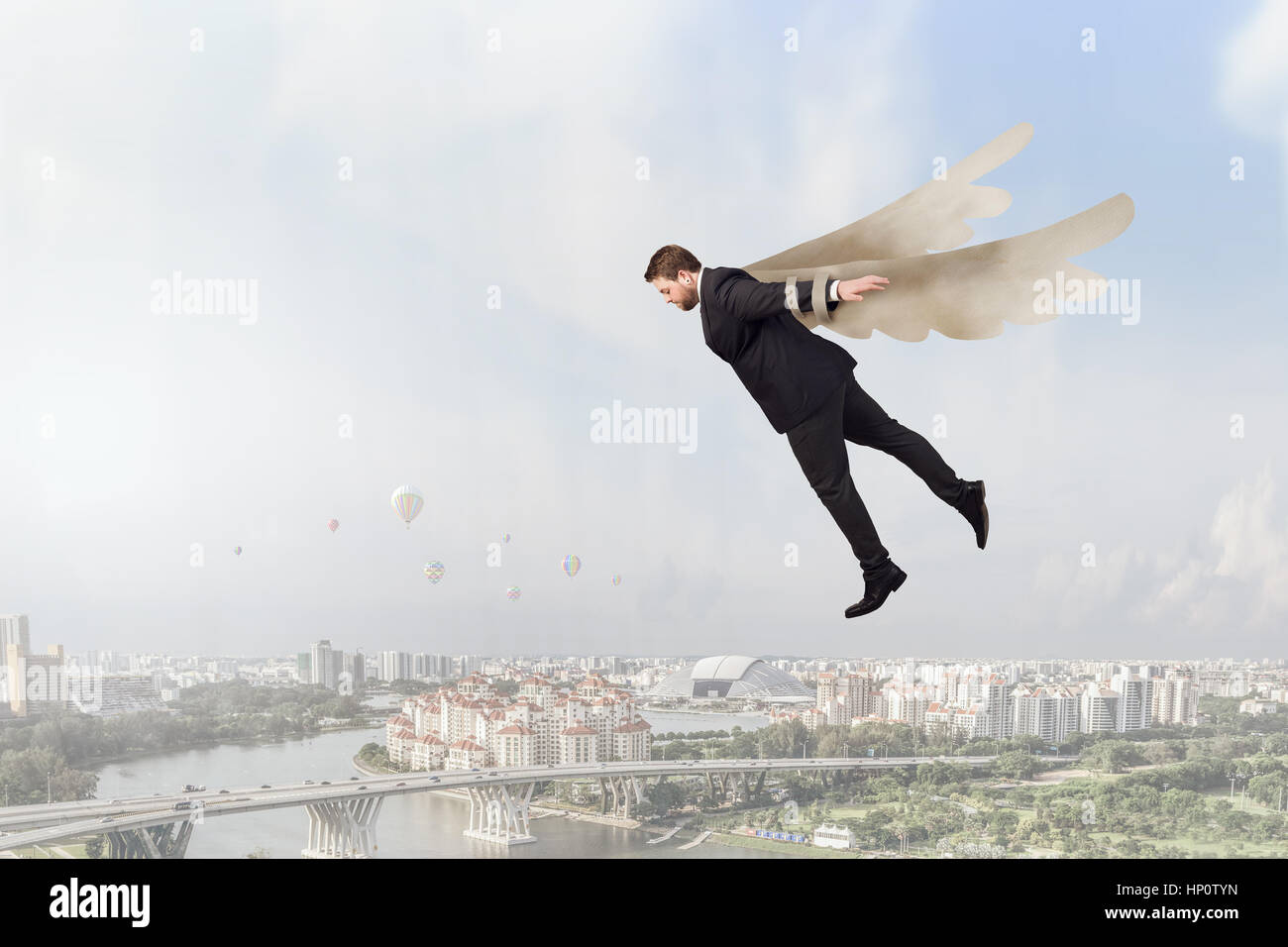 Young businessman with paper wings flying in sky Stock Photo - Alamy
