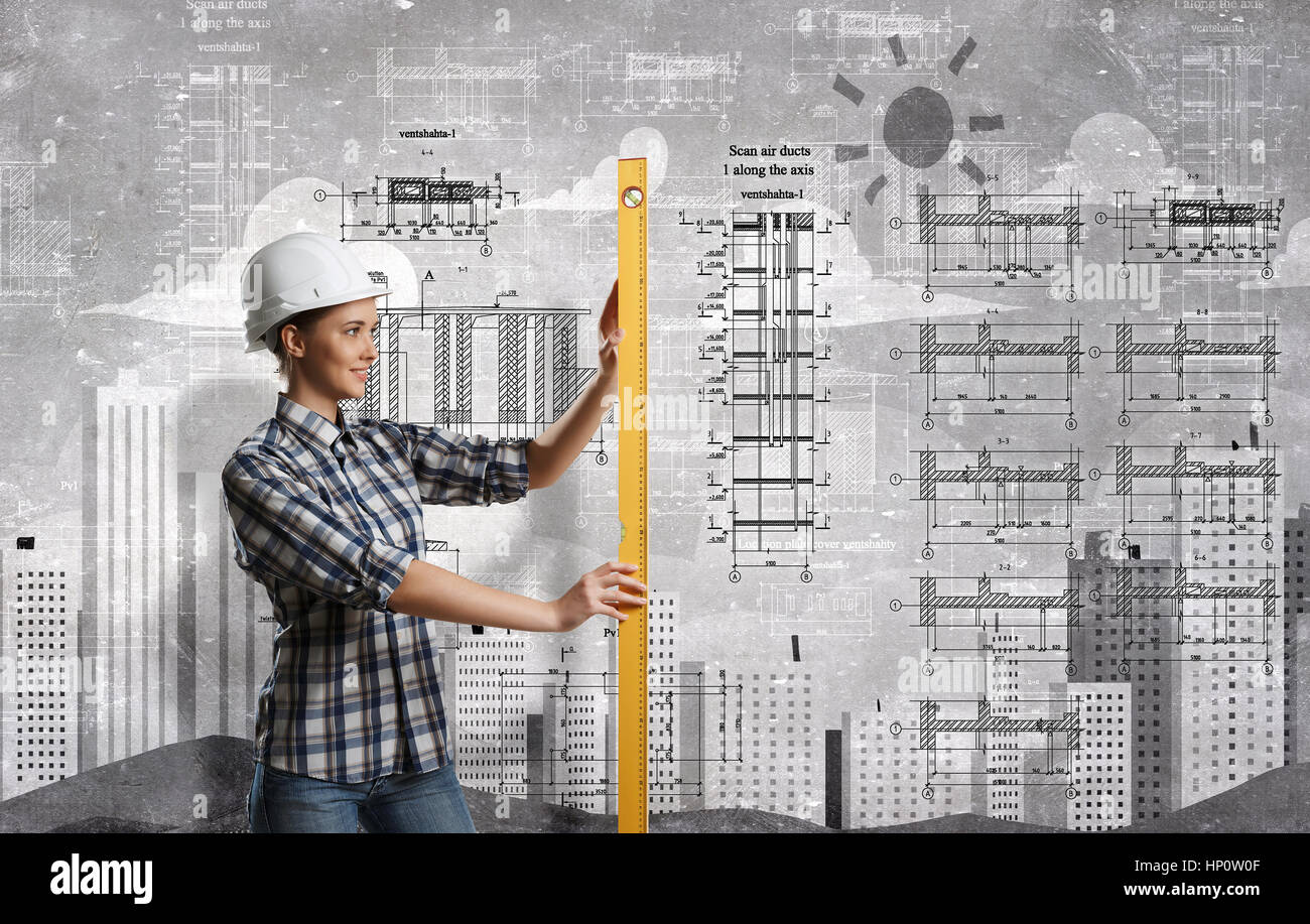 Portrait of attractive woman mechanic with wooden ruler in hands Stock ...