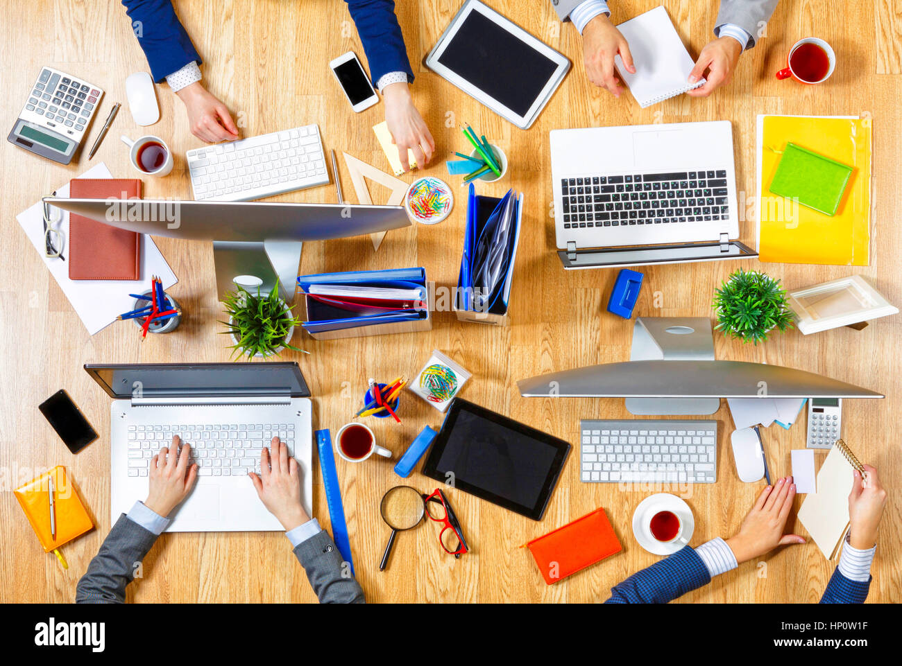 Top view of office table with four colleagues working together Stock ...