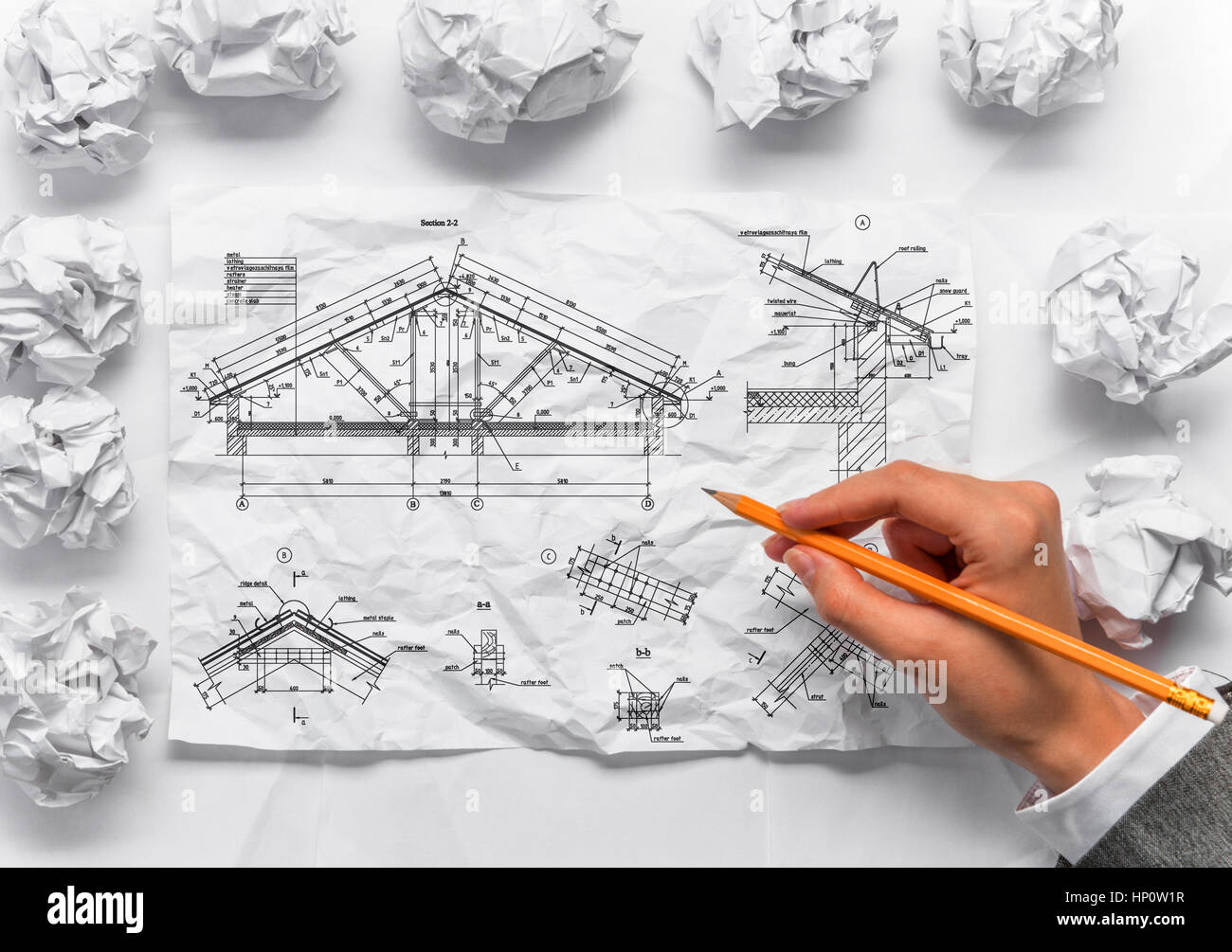 Hand of businesswoman drawing buildings on crumpled paper Stock Photo ...
