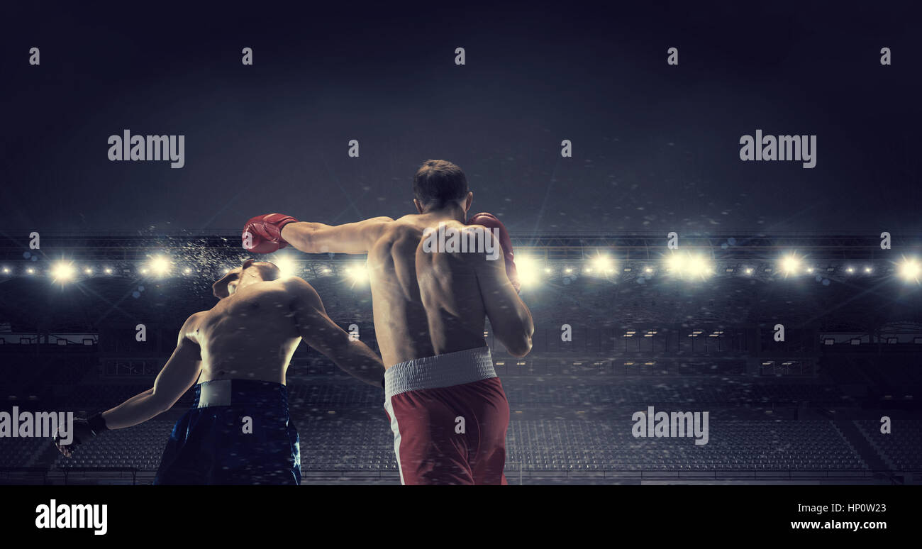 Two professional boxers are fighting on grand arena. Mixed media Stock ...