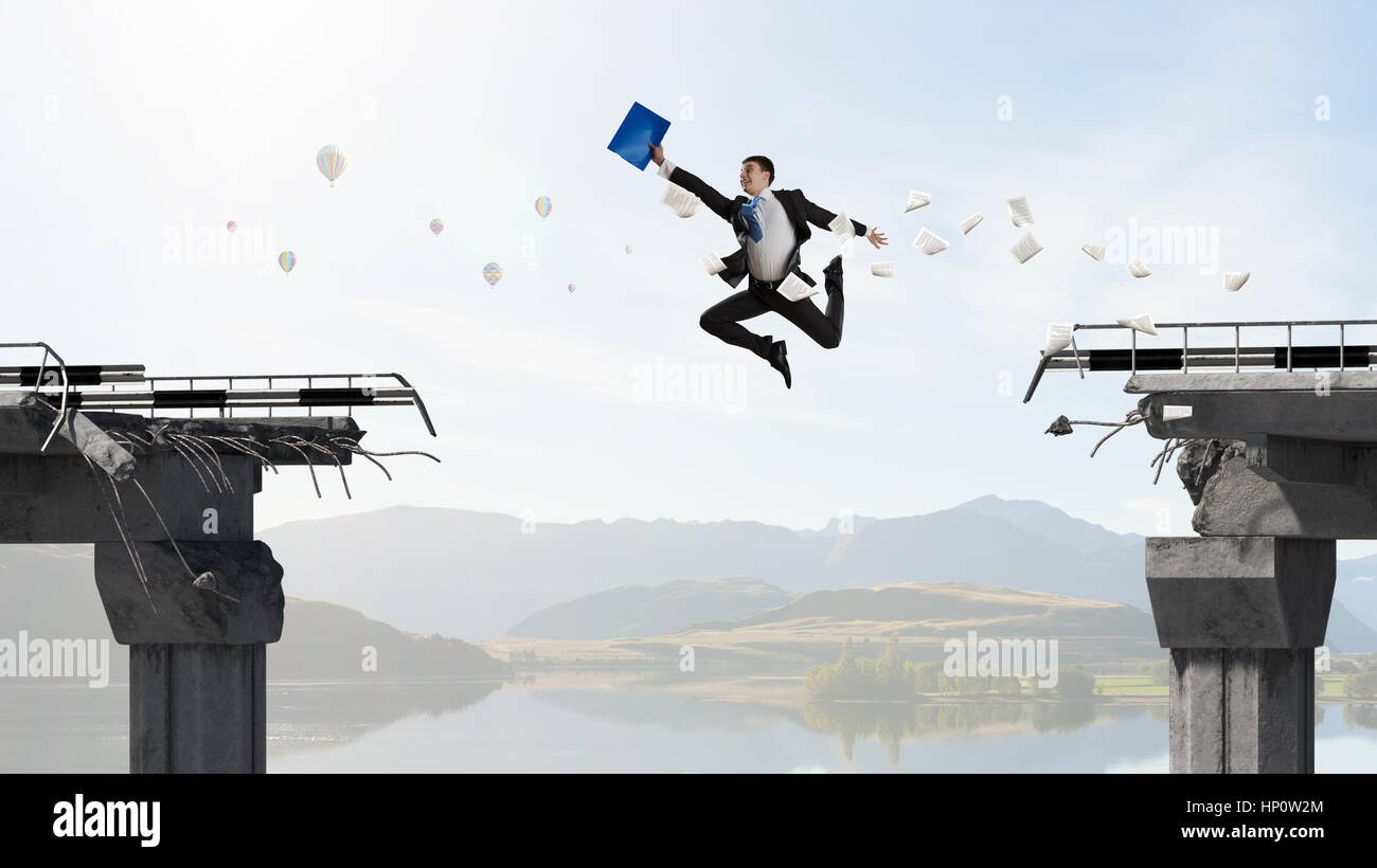 Businessman jumping over a gap in bridge as symbol of problem ...