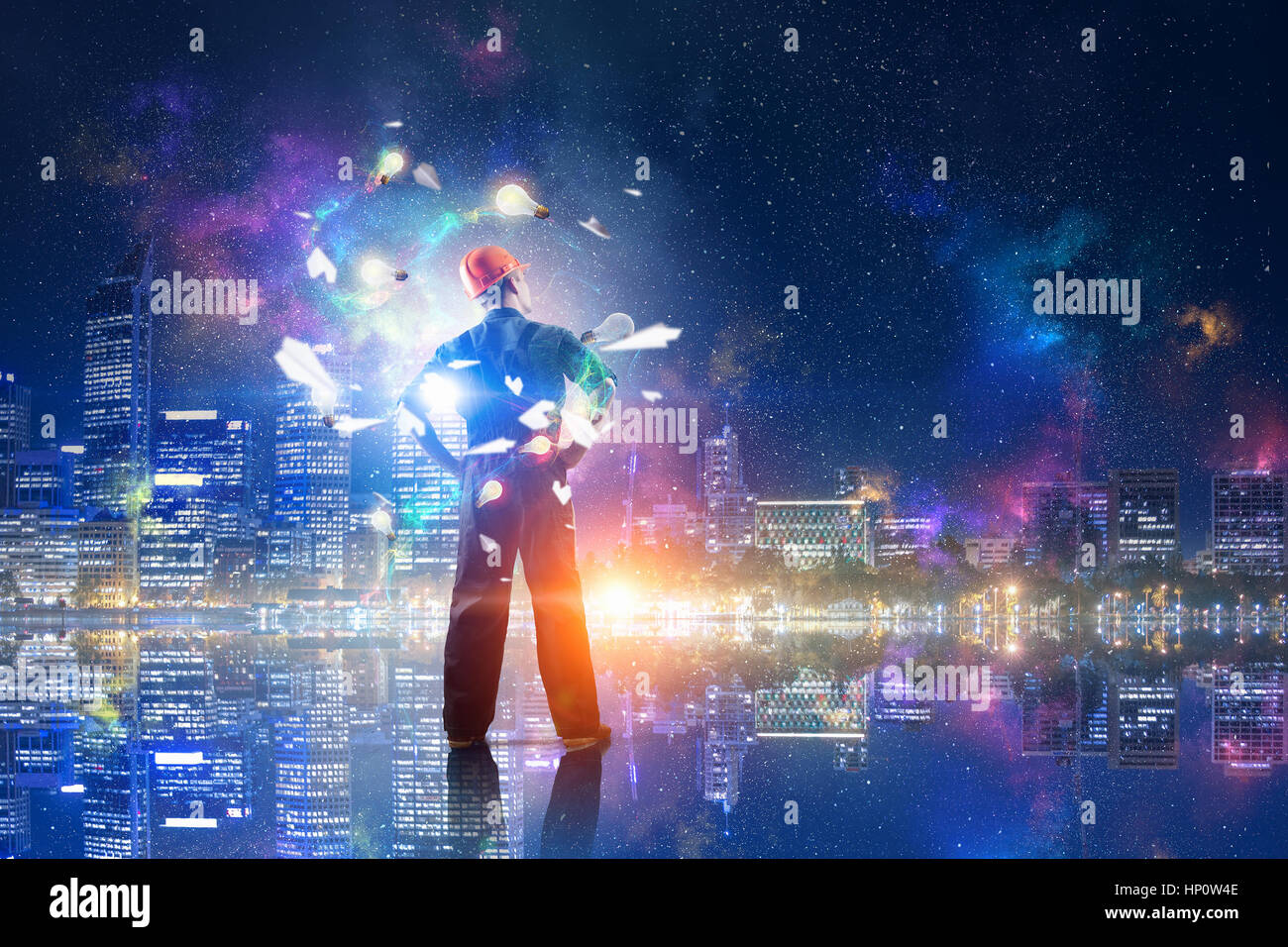 Back view of builder man looking at modern city Stock Photo - Alamy