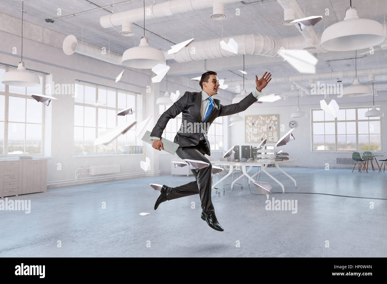 Young cheerful businessman in modern office celebrating his success ...