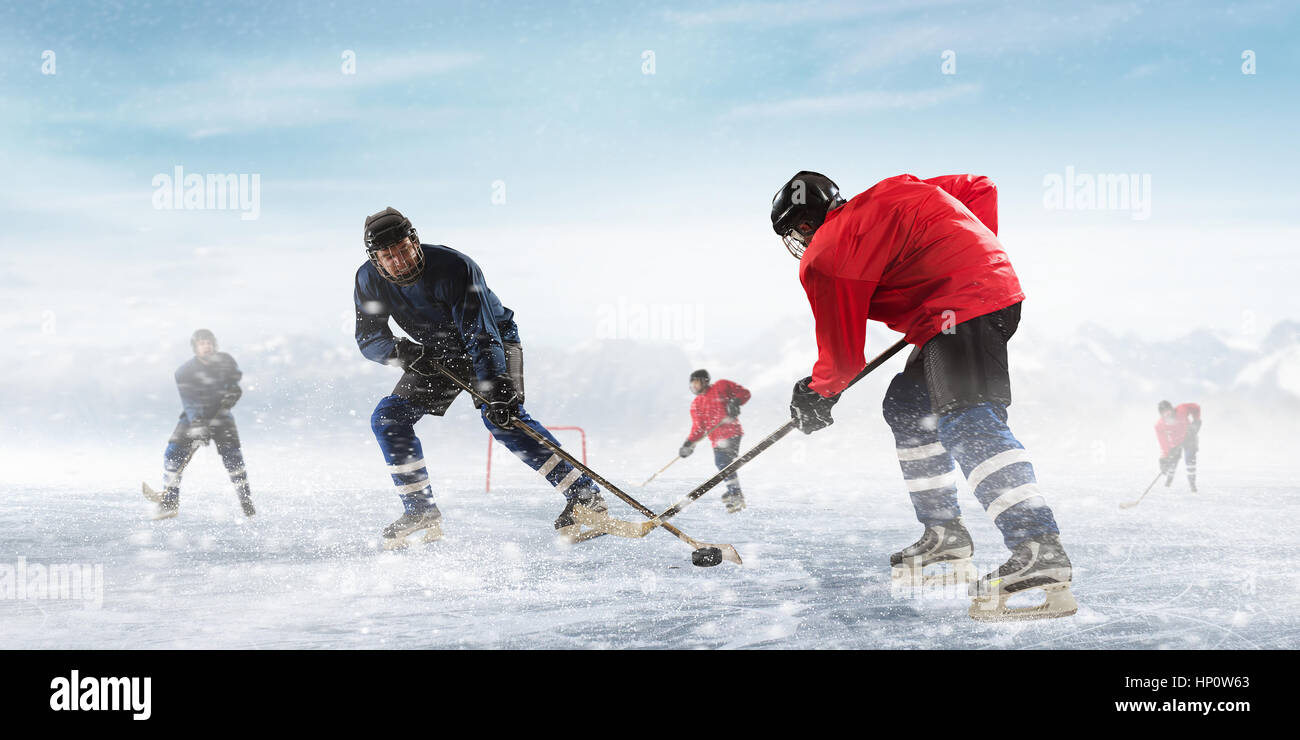 Hockey players fighting for puck outdoors at winter Stock Photo - Alamy