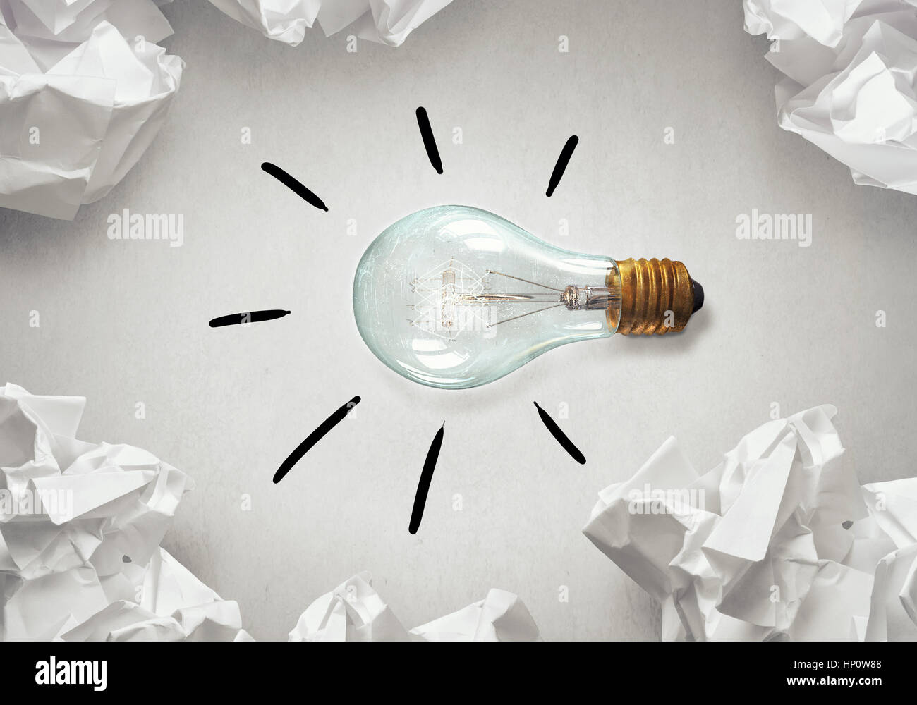 Glowing light bulb and paper balls on white background Stock Photo - Alamy