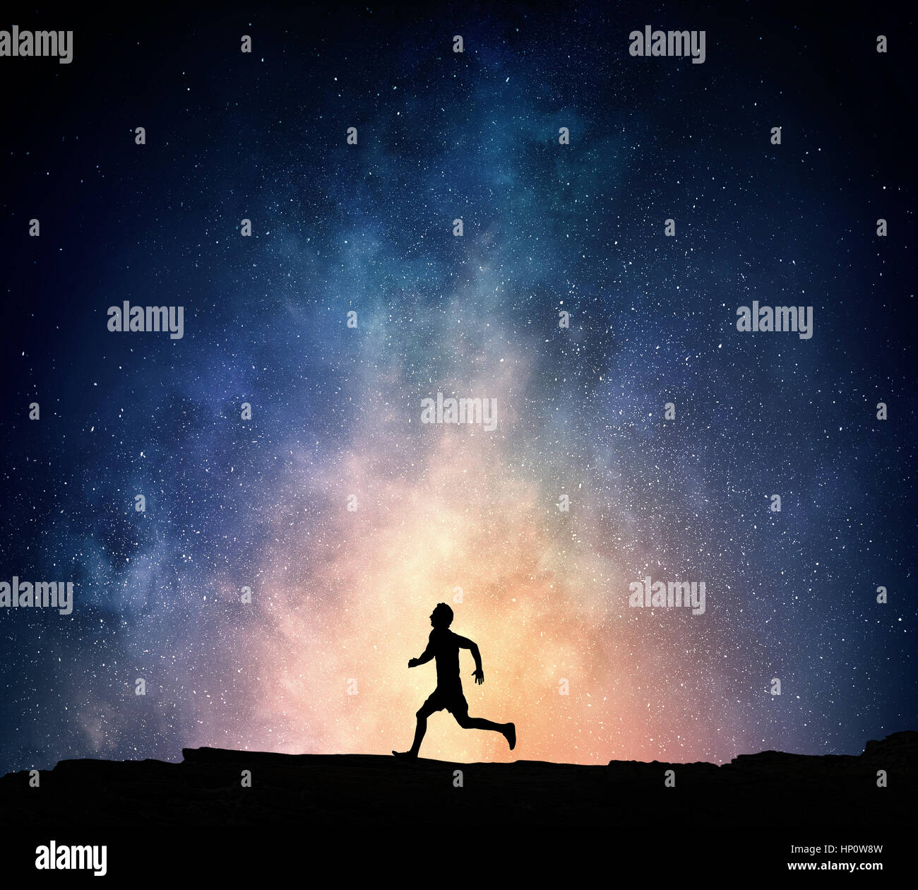 Silhouette of sport man running against starry sky Stock Photo - Alamy