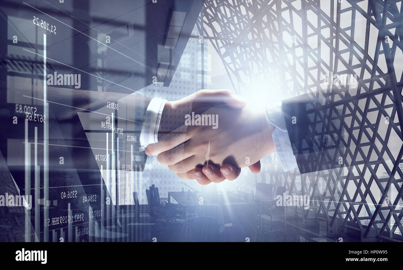 Close up of business handshake against office interior background ...