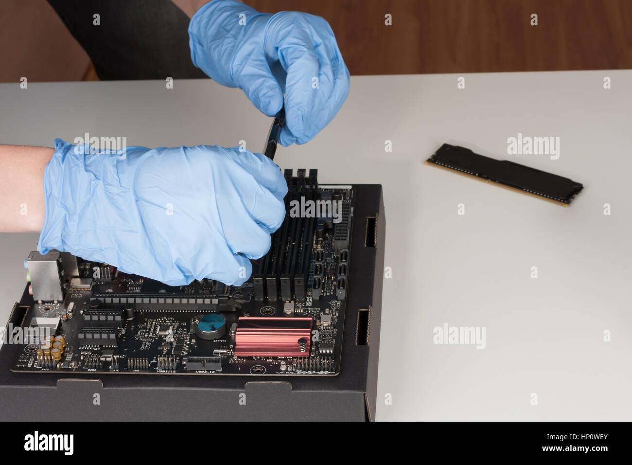 Close up of man hands with gloves installing Ram DDR4 memory module in ...