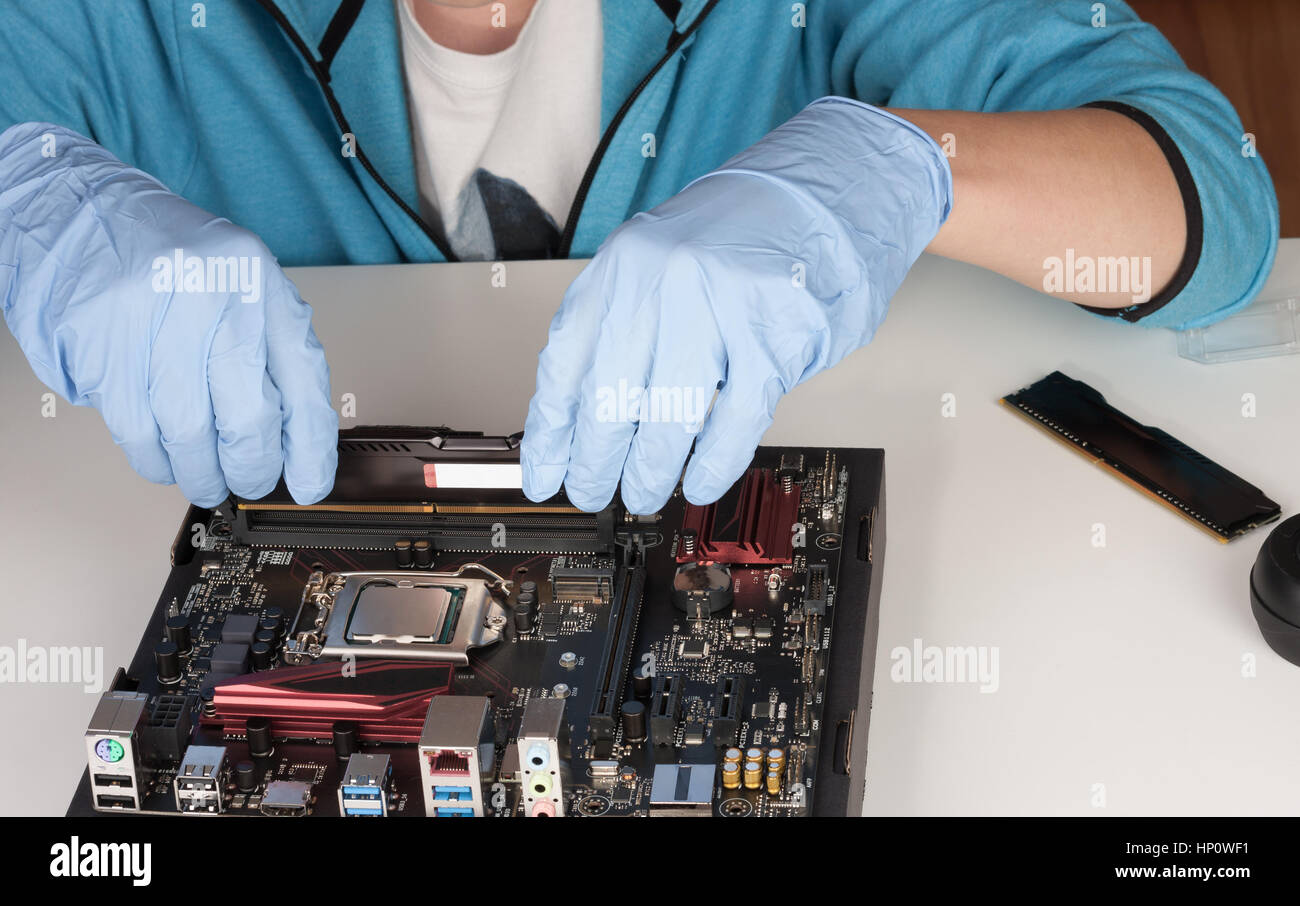 Close up of man hands with gloves installing Ram DDR4 memory module in ...