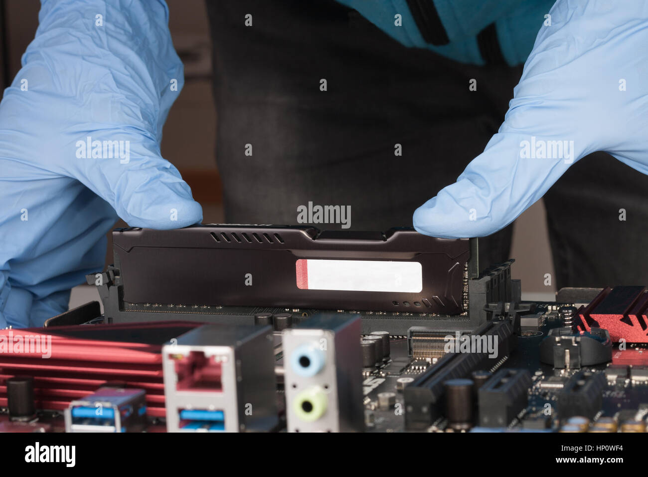Close up of man hands with gloves installing Ram DDR4 memory module in ...