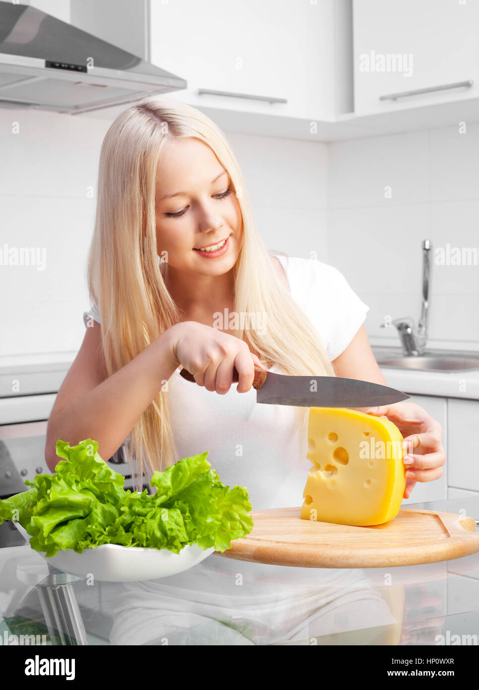 happy young beautiful woman eating cheese at home Stock Photo - Alamy