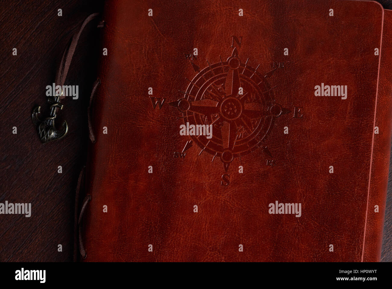 Brown navigation journal with leather texture cover on wooden table ...