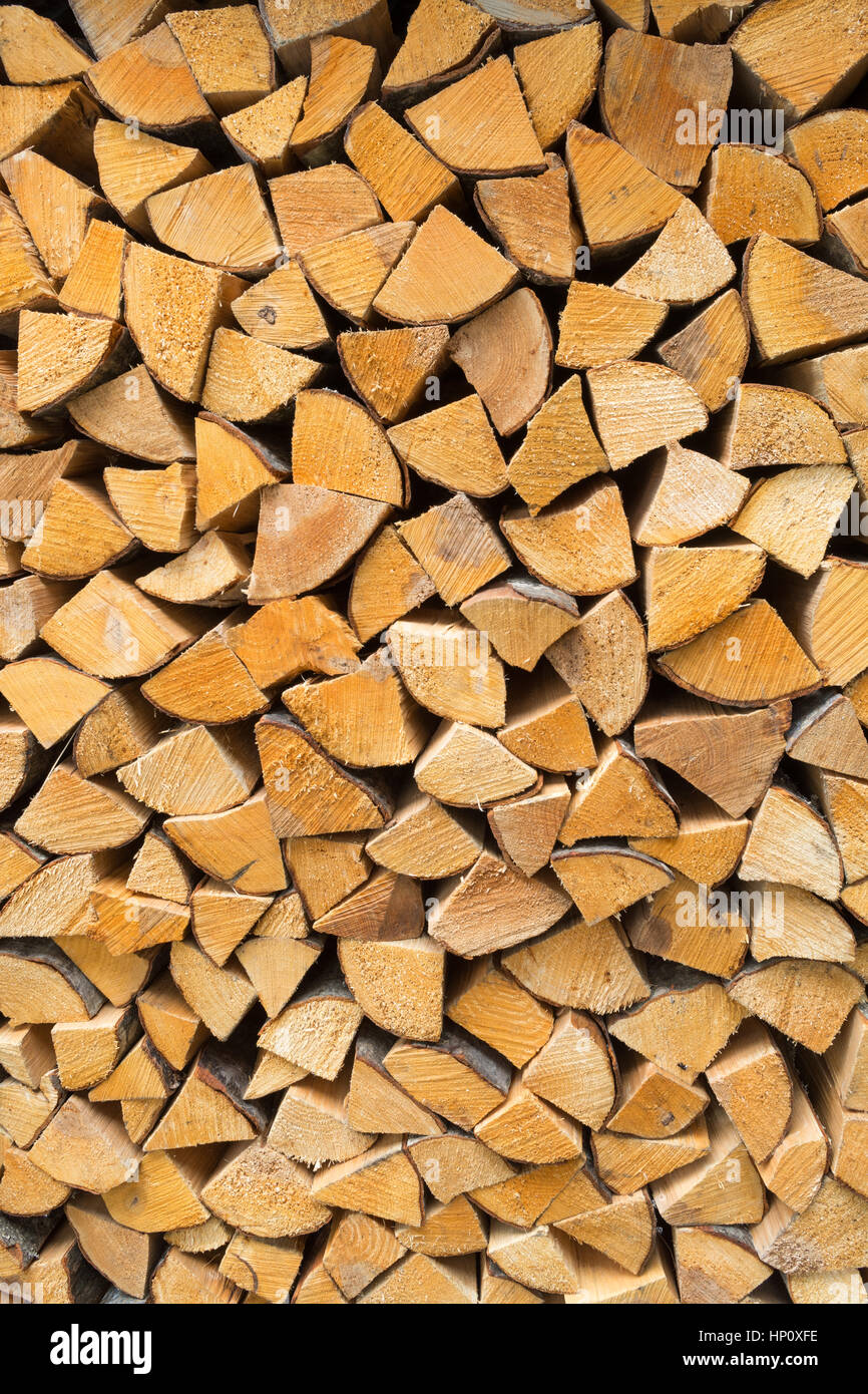firewood - seasoned kiln-dried split logs neatly stacked background ...