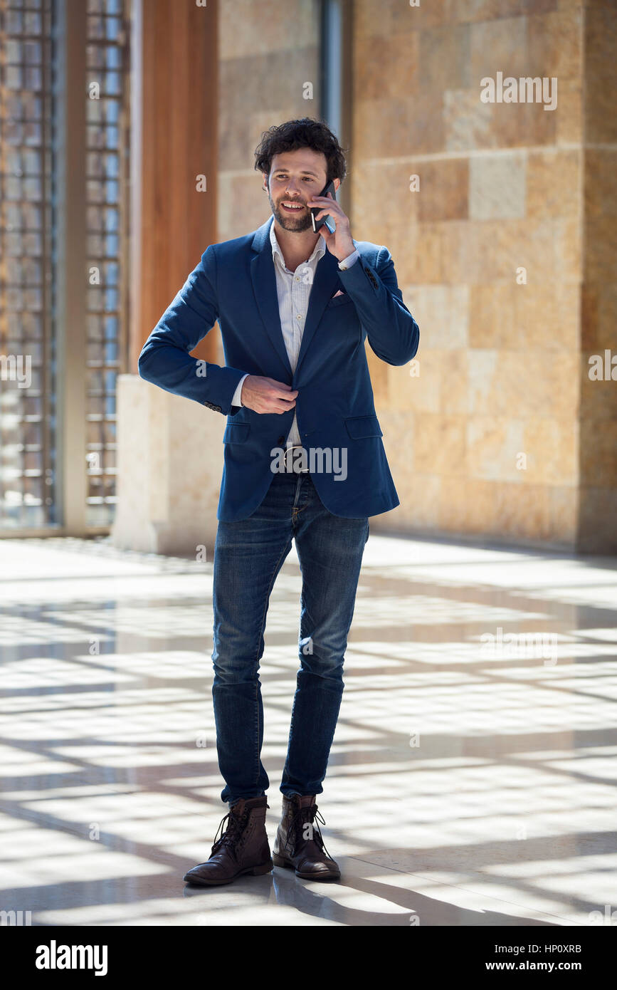 Man walking and talking on cell phone Stock Photo - Alamy
