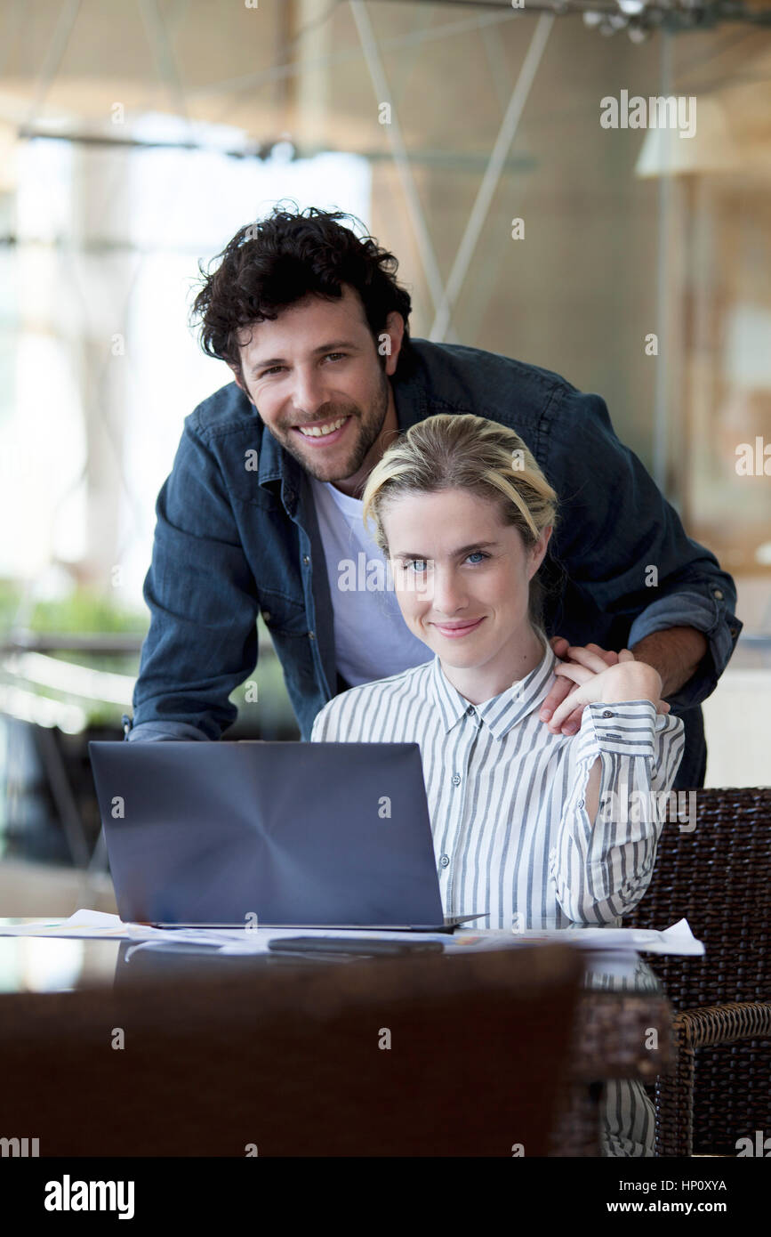 Couple using laptop computer together Stock Photo - Alamy