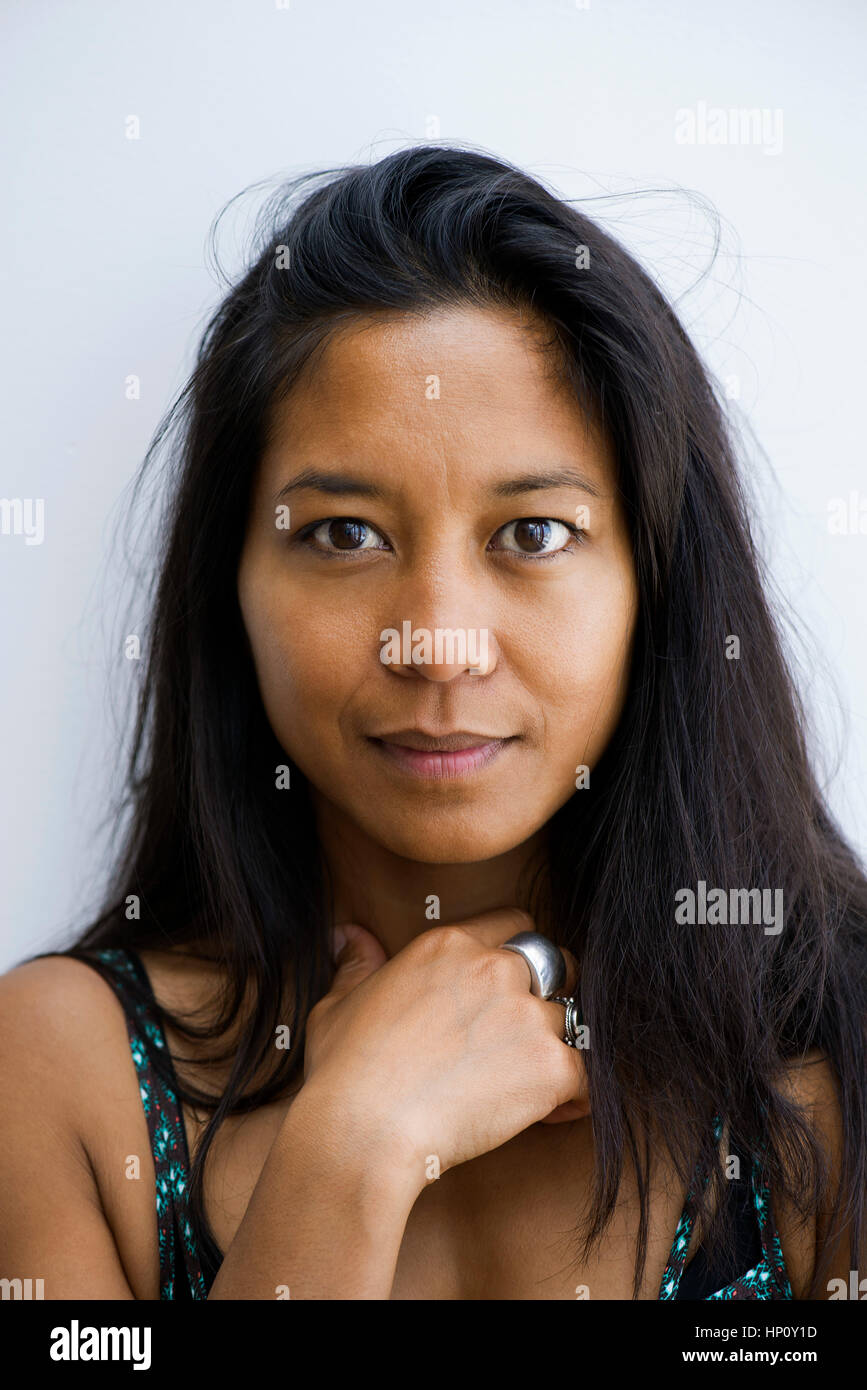 Woman with hand on neck, smiling, portrait Stock Photo - Alamy