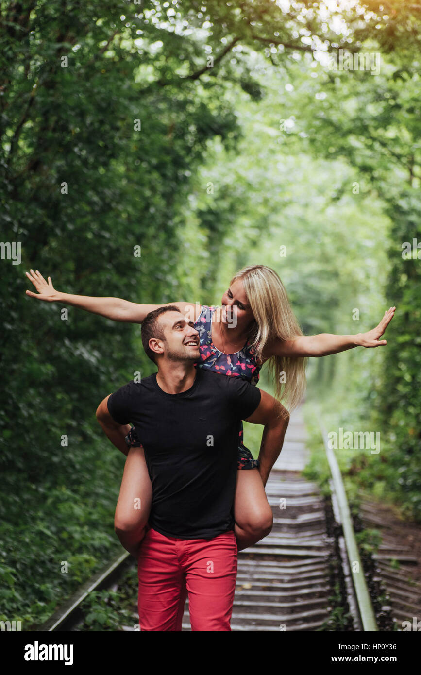 Loving couple in love tunnel iron road Stock Photo - Alamy