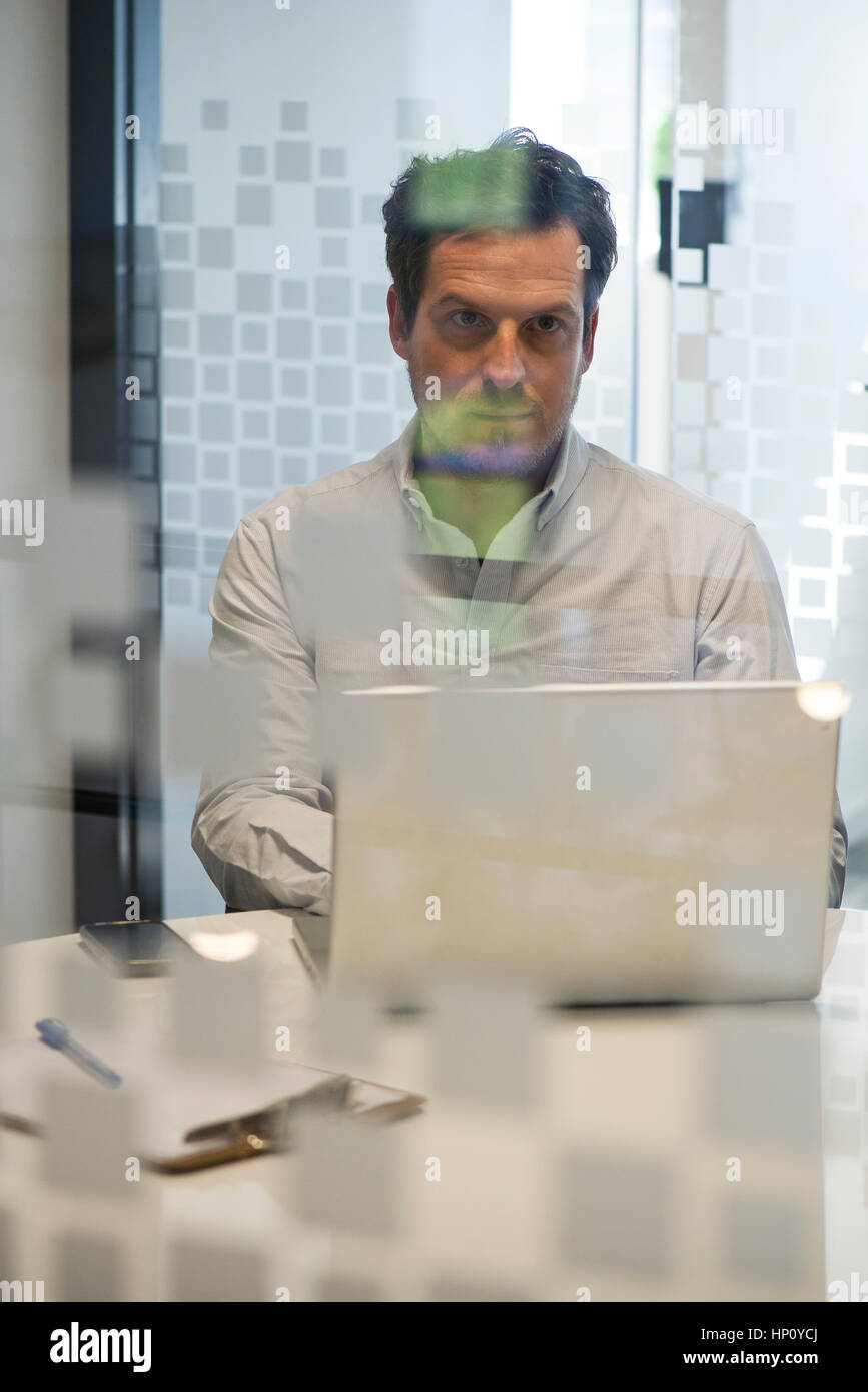 Man in office using laptop computer Stock Photo - Alamy