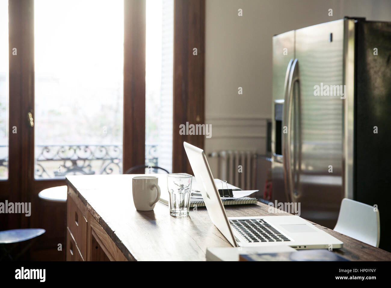 Laptop computer on kitchen counter Stock Photo - Alamy