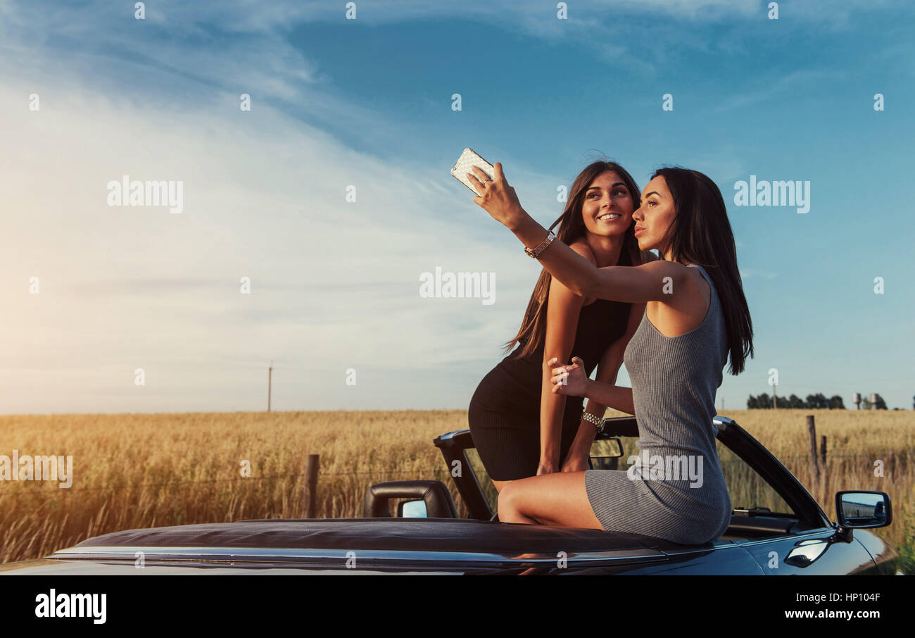 Beautiful two girls are photographed on the road Stock Photo - Alamy