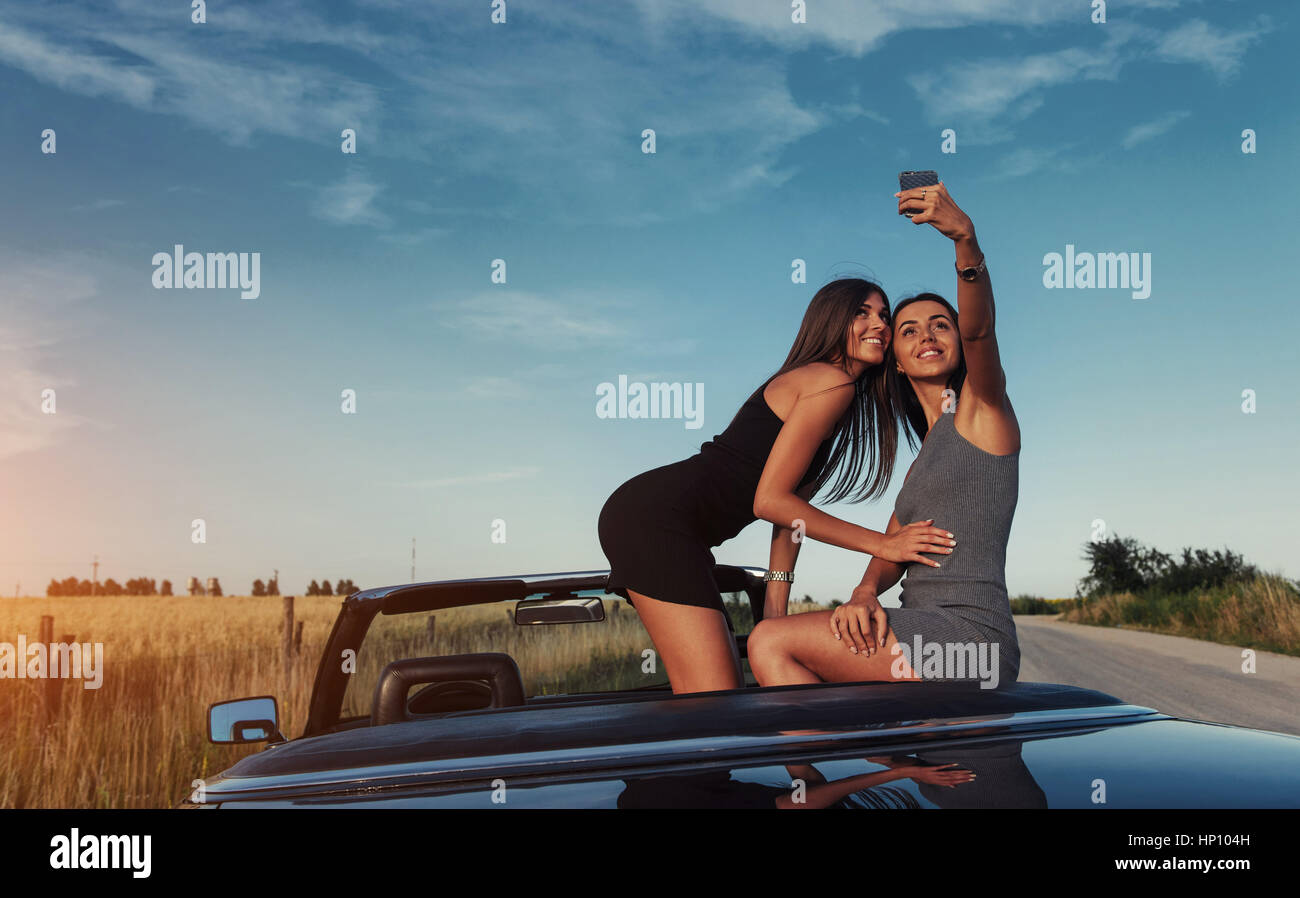 Beautiful two girls are photographed on the road Stock Photo - Alamy